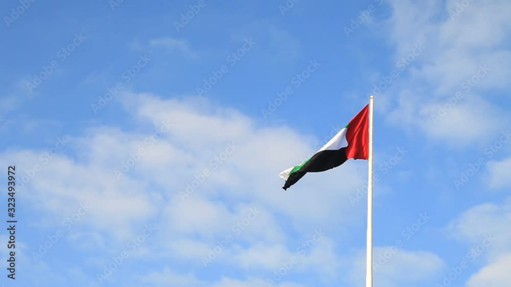 UAE flag waving in the sky, national symbol of UAE. UAE National Day ...
