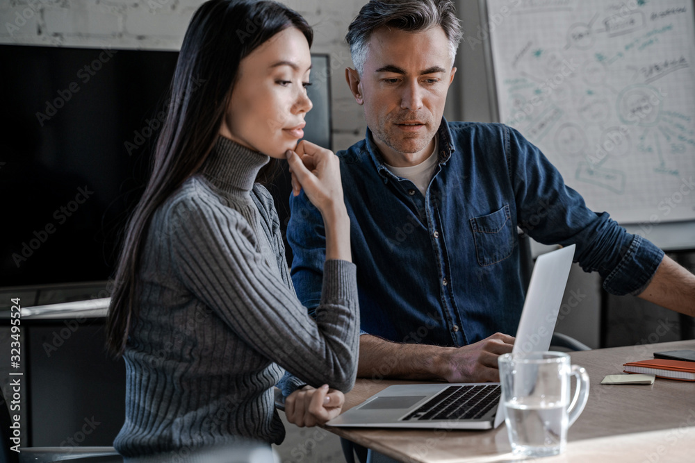 Two office people man and woman work together on one common project ...