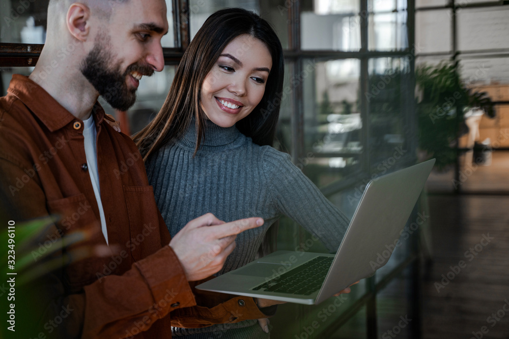 International colleagues work together with laptop computer, teamwork ...