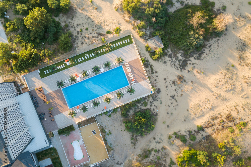 Top down aerial view of hotel swimming pool with crystal blue water ...
