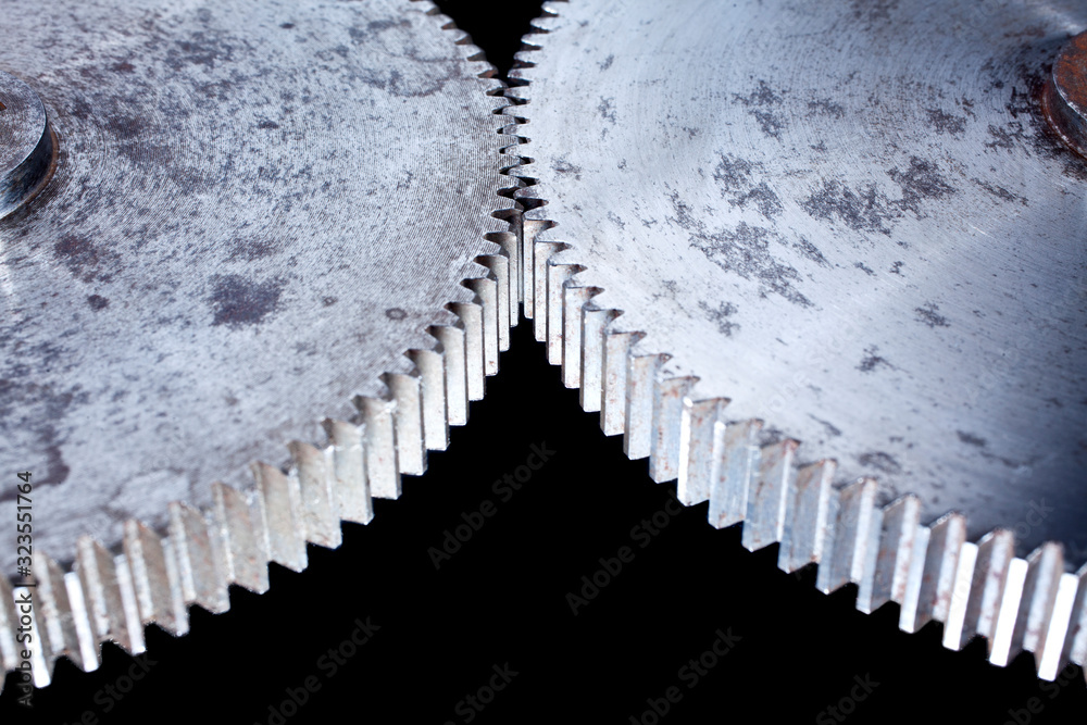 closeup of two metal cogs cogwheels gearwheels on black background ...