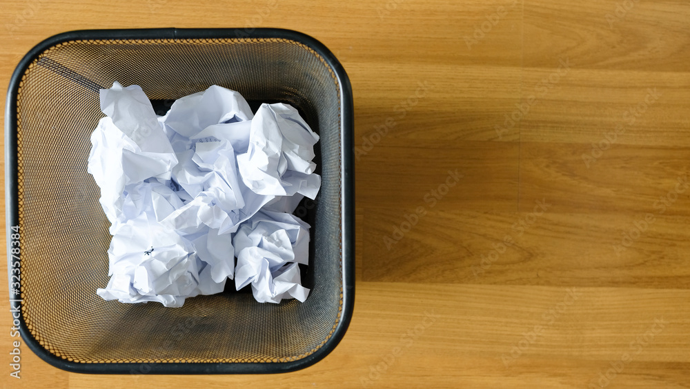 Throwing many crumpled paper ball into black garbage at the office. Its ...