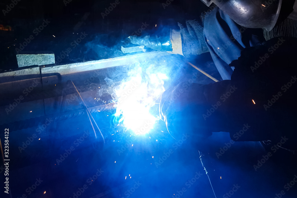 Welding of steel reinforcement. Sparks and light from welding. E Stock ...