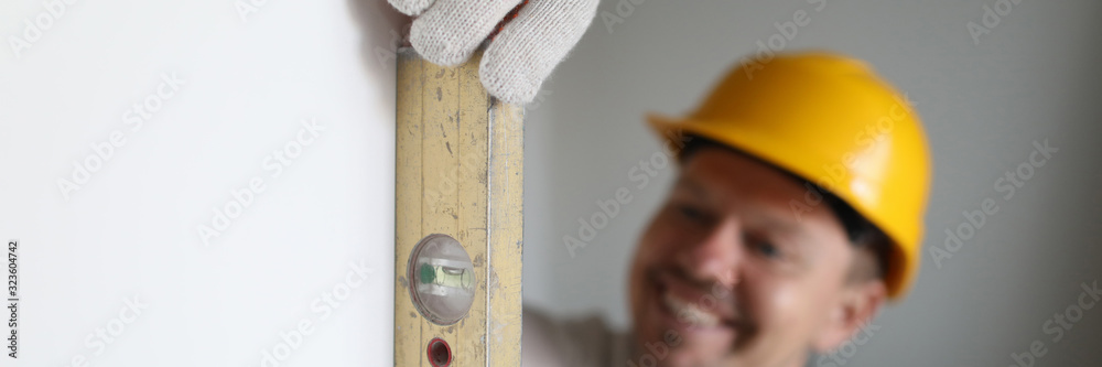 Foto de Focus on handyman hands holding measuring ruler and fixing ...