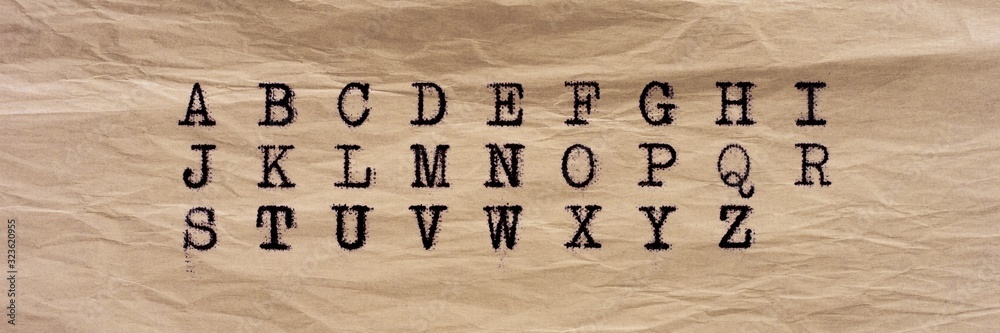Alphabet written with an old typewriter on old paper sheet. Panoramic ...