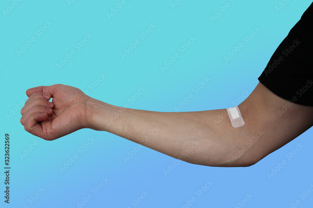 male hand sealed on the inside of the elbow with a medical plaster ...