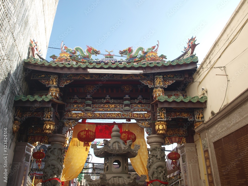 Arch at the entrance of buddhist temple. Upper part of an entrance ...