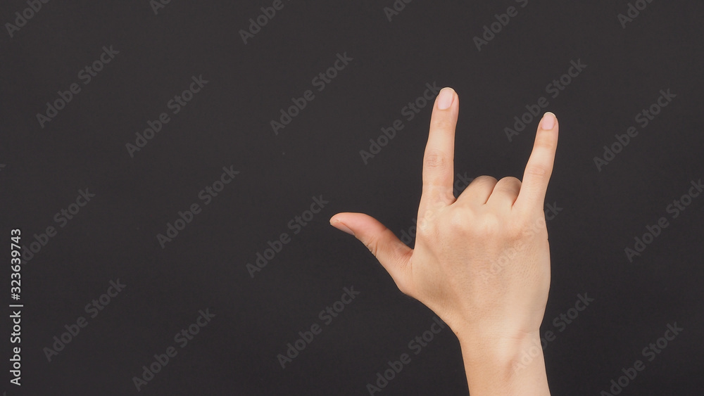 The" i love you" hand sign.Doing with right back hand on black ...
