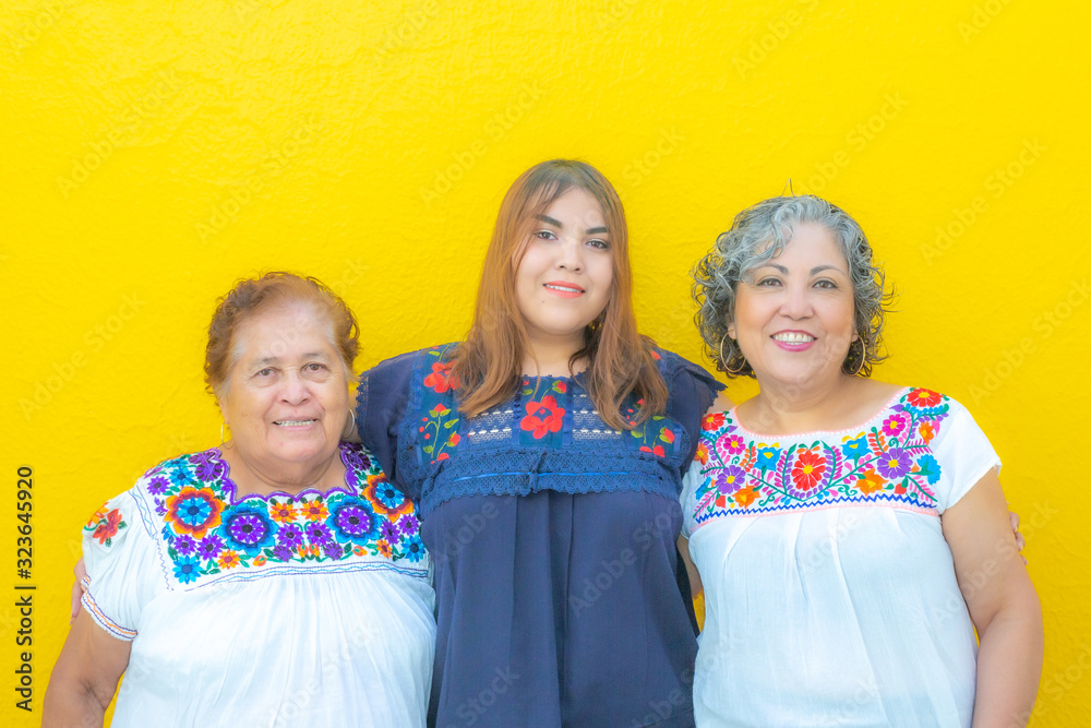 Three generations of Mexican women smiling, grandmother, granddaughter ...