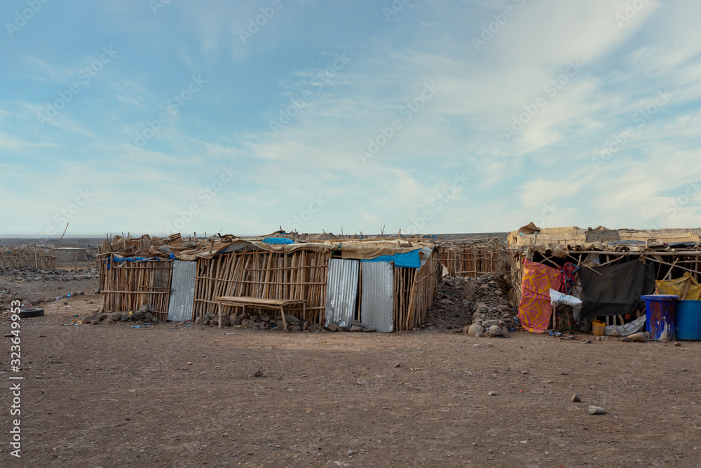 Afar tribe house in the danakil depression desert, peoples go by camel ...