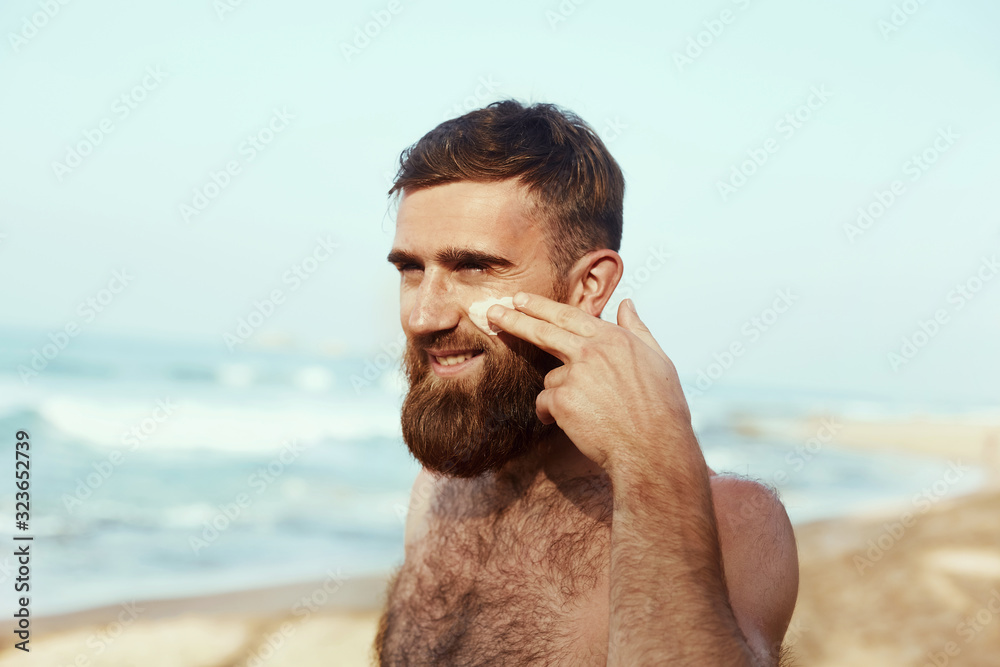 Handsome Man with beard, In Sunglasses Sunbathing With Sunscreen Lotion ...