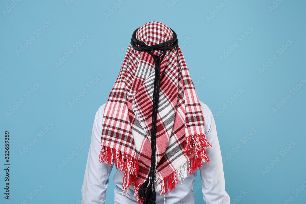 Back rear view of young arabian muslim man in keffiyeh kafiya ring igal ...