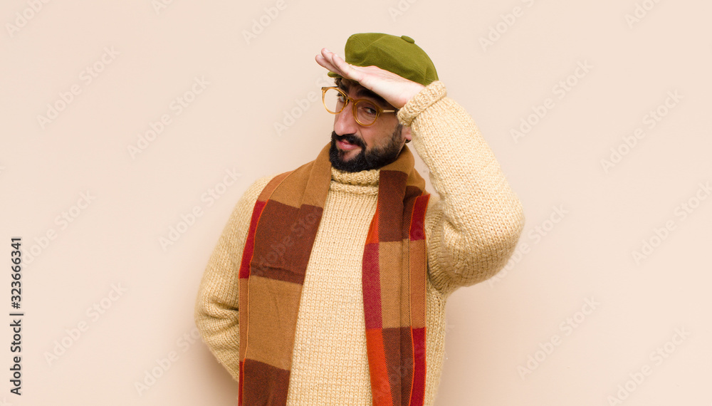 young cool bearded man greeting the camera with a military salute in an ...