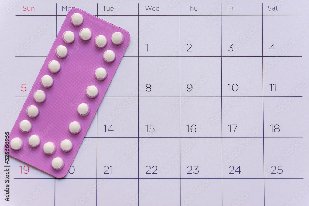 birth-control pill with date of calendar background, health care and ...