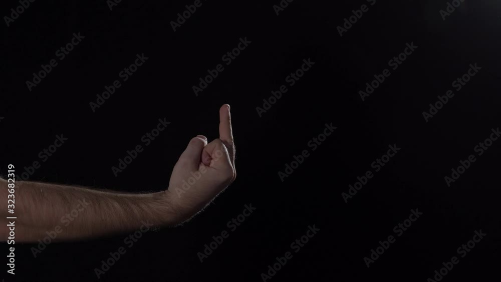 Man's hand showing middle finger gesture on black background. 4K ...