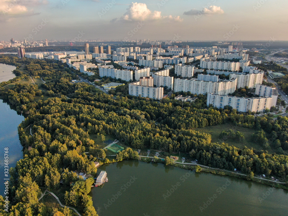 Top view of the outskirts of the city, in the frame green forests and a ...