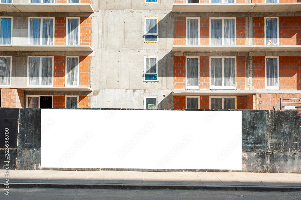 Blank white banner for advertisement on a fence of a apartment building ...