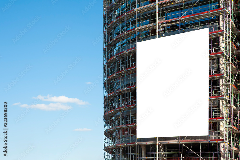 Blank white banner for advertisement hanging on the scaffolding of ...