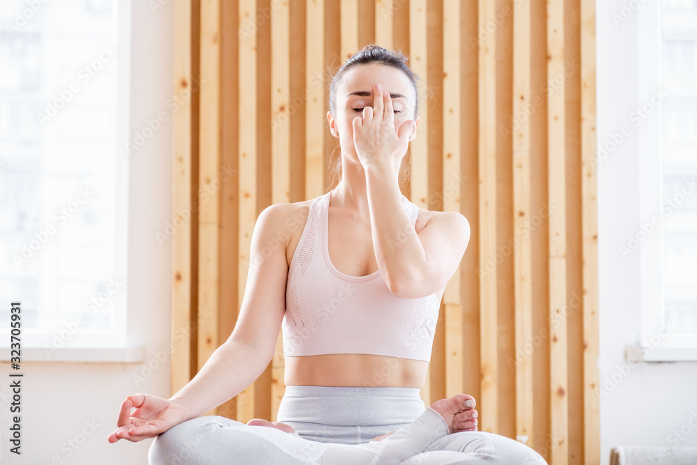 Side view of young healthy woman sitting in lotus mudra alternate ...