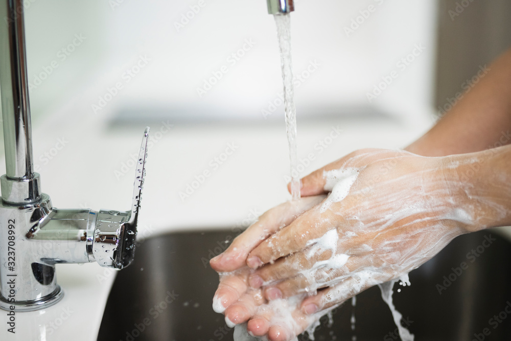 washing hands in kitchen sink Stock Photo | Adobe Stock