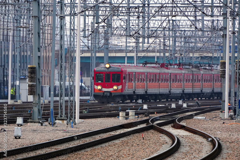 The red old electric train arrives at the station of the railway ...