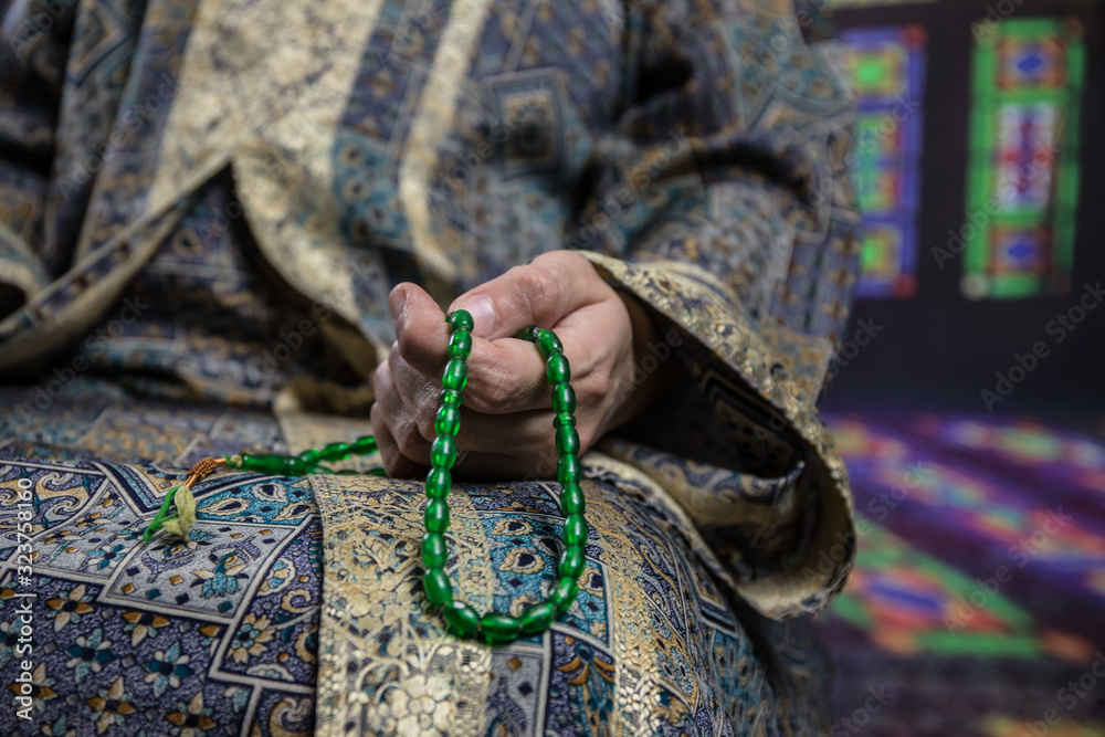Muslim woman praying for Allah muslim god at room near window. Hands of ...