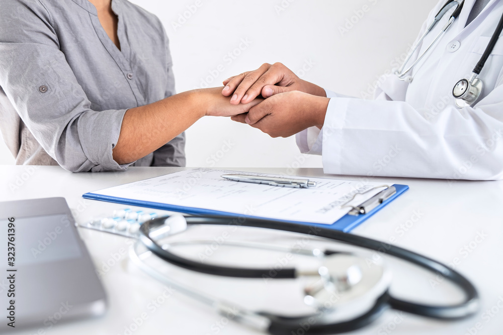 Hand of doctor touching patient reassuring for encouragement and ...