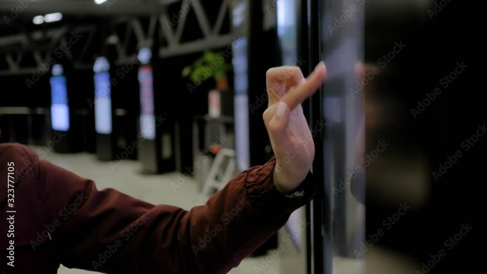 Woman hand using interactive touchscreen display of electronic ...