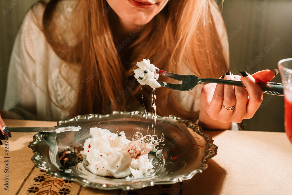 Girl in night gown combing having dinner. Lard with hair. Bizarre ...
