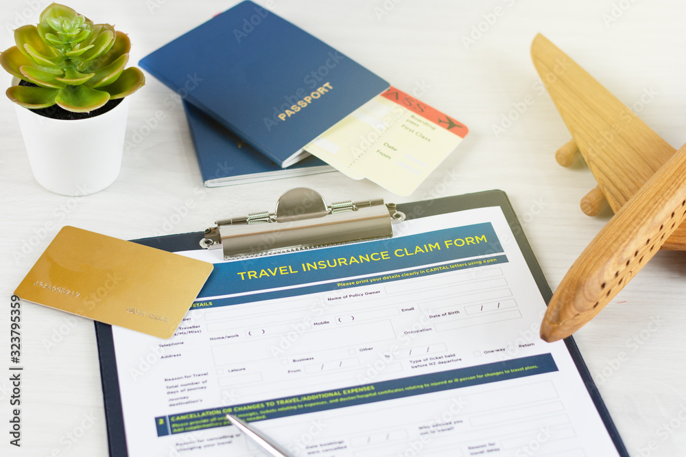 Travel insurance policy claim form with a boarding pass and passport on ...