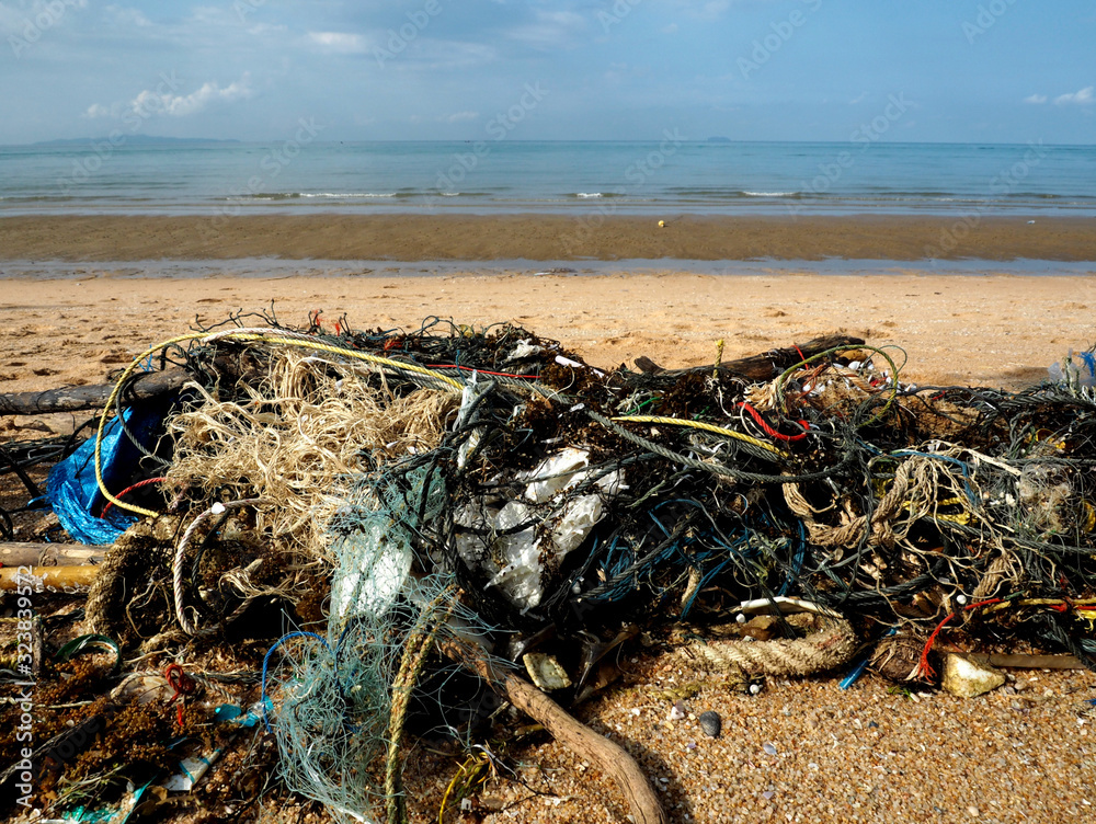 Abandoned garbage is on the beach. Plastic fishing nets are not ...