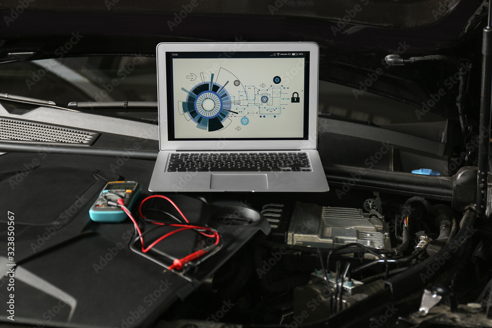 Laptop with diagram on auto engine. Modern car diagnostic Stock Photo ...