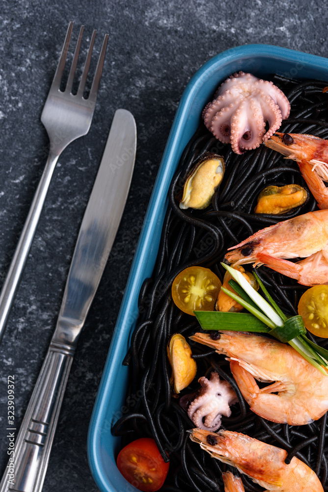 unusual dish of black spaghetti with cuttlefish ink with seafood and ...