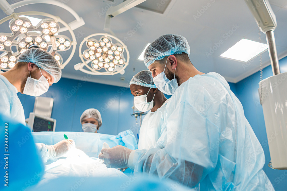 An international team of doctors performs a complex surgical operation ...