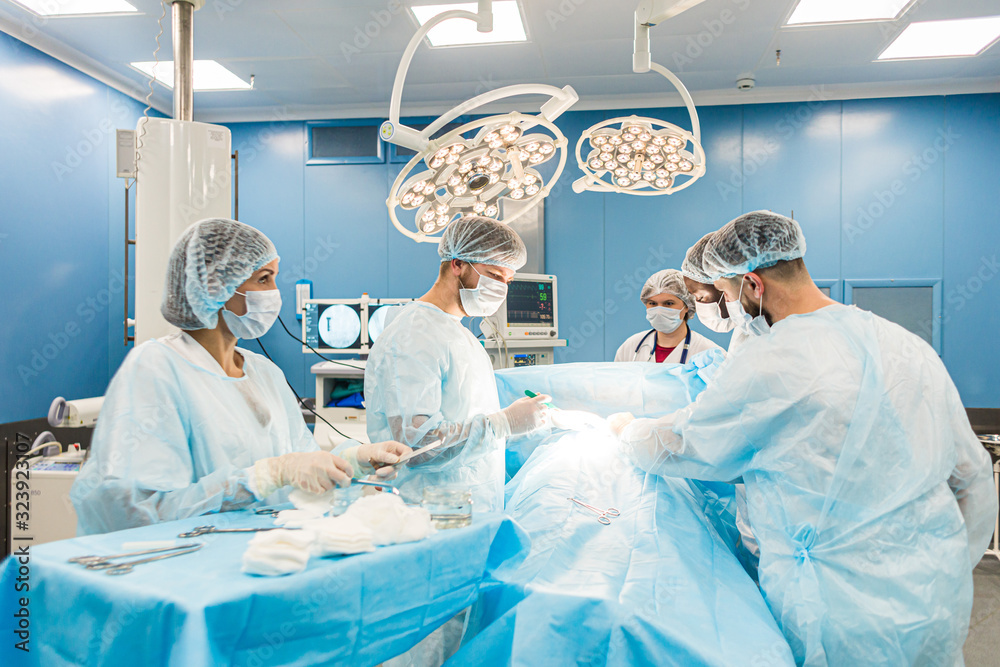 An international team of doctors performs a complex surgical operation ...