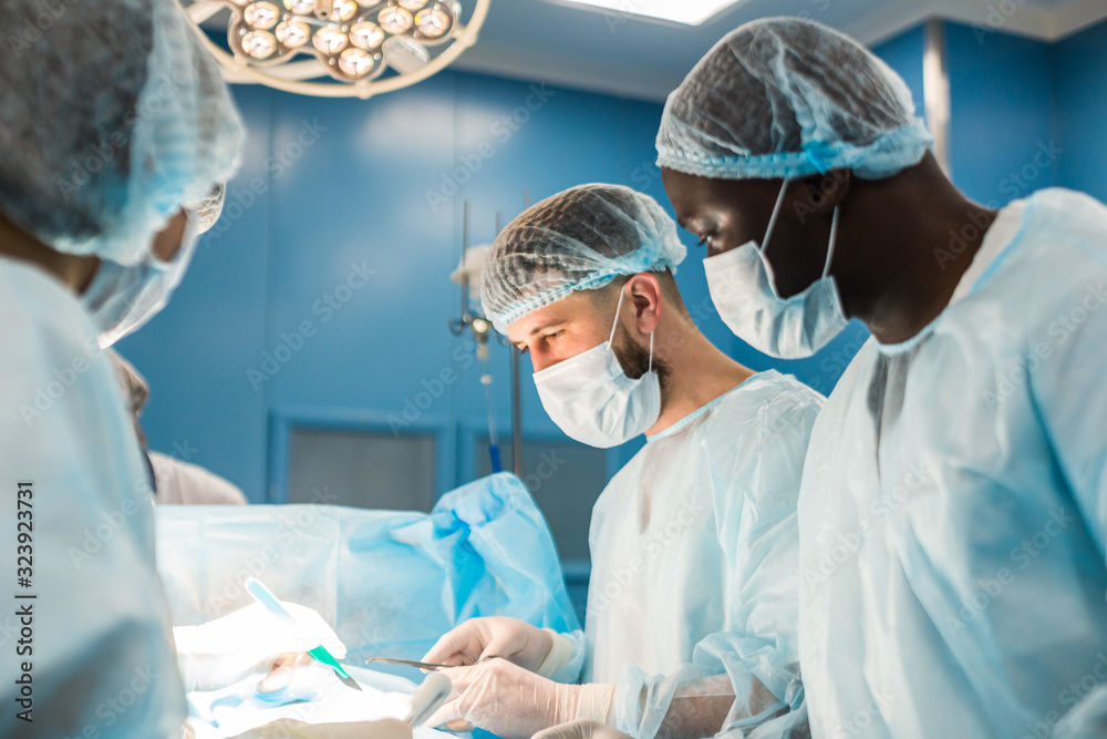 An international team of doctors performs a complex surgical operation ...