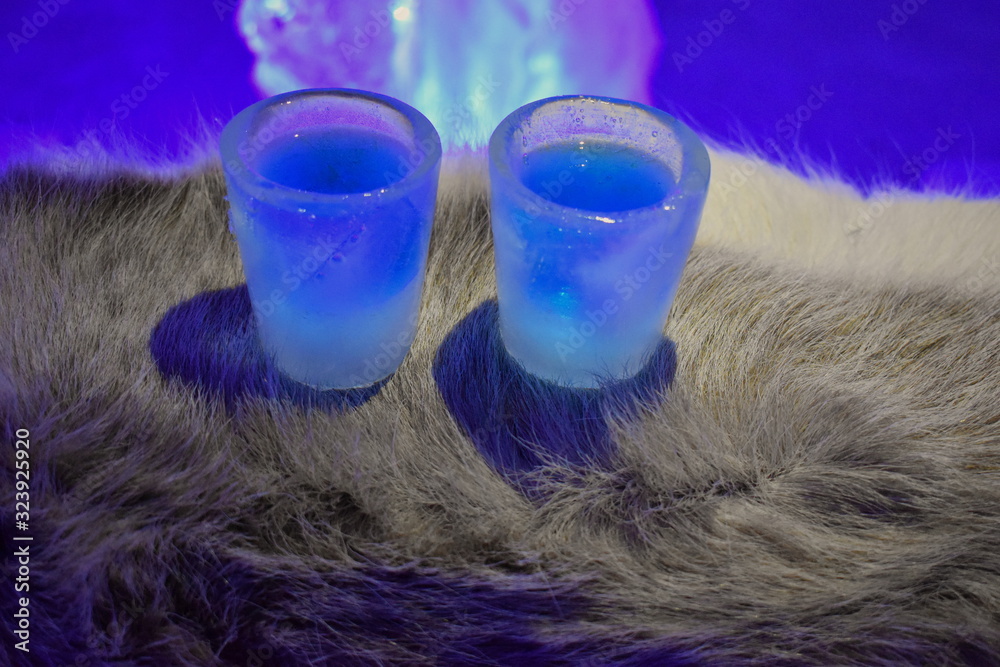 Flavored vodka spirit shots in ice glasses on reindeer hide Alcoholic ...