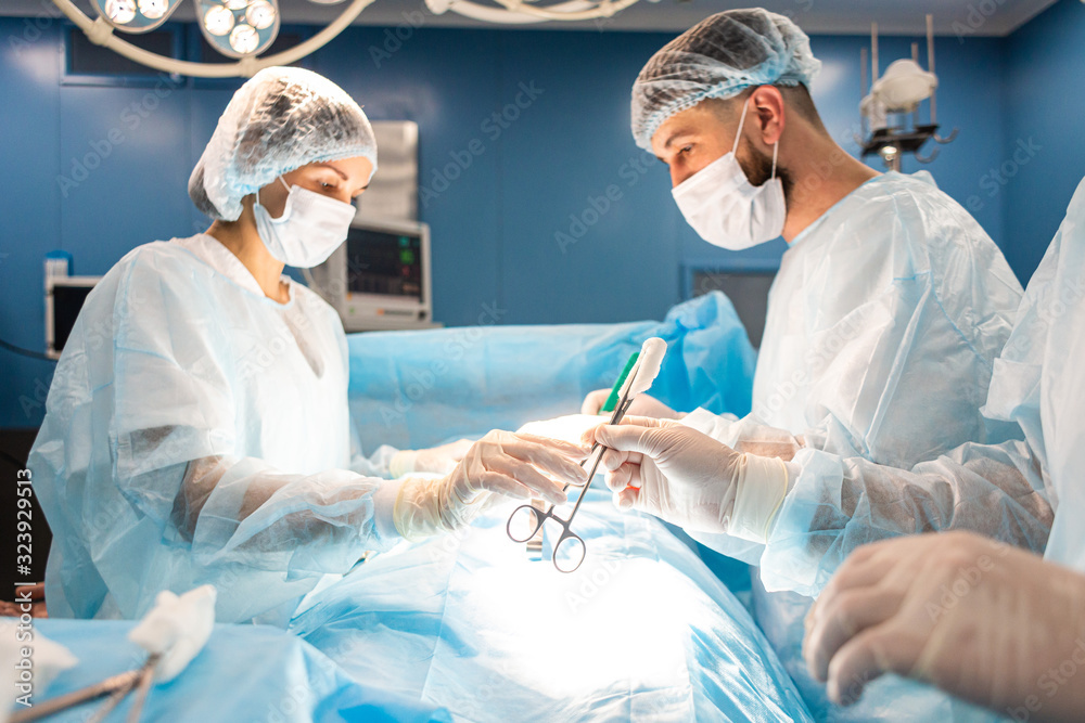 An international team of doctors performs a complex surgical operation ...