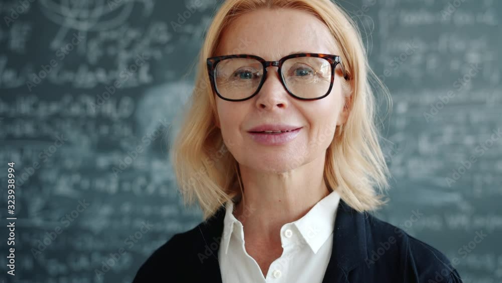 Portrait of attractive adult lady smart professor standing indoors in ...
