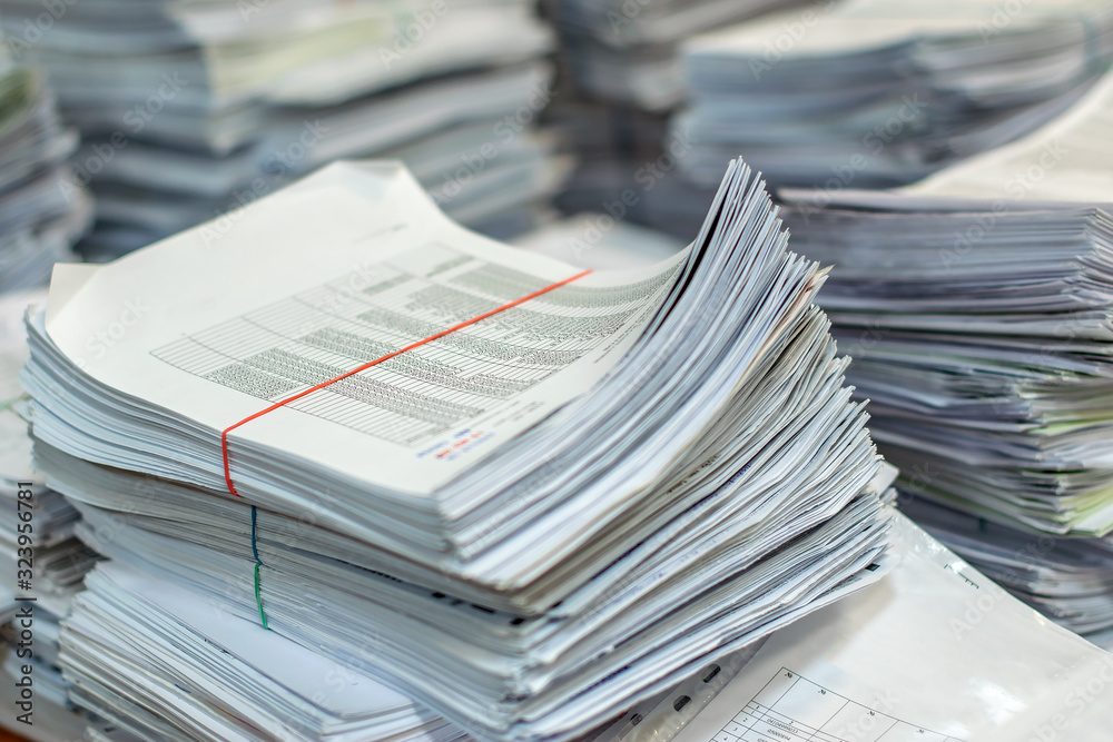 bundles bales of paper documents. stacks packs pile on the desk in the ...