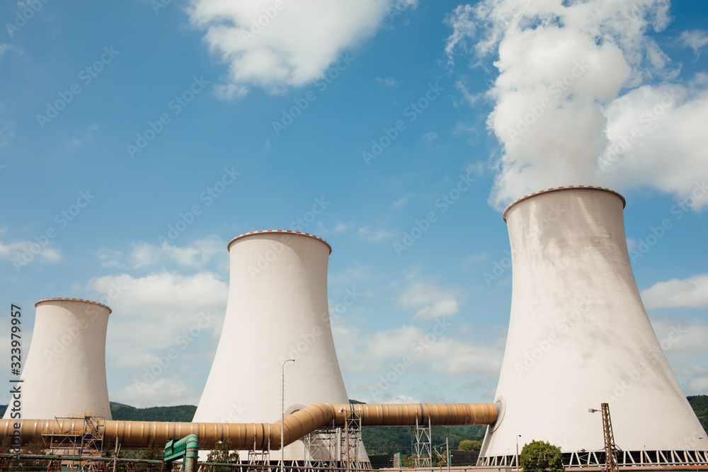 Power plants in the blue sky white clouds the sky background. Tops of ...