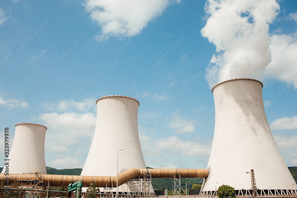 Power plants in the blue sky white clouds the sky background. Tops of ...