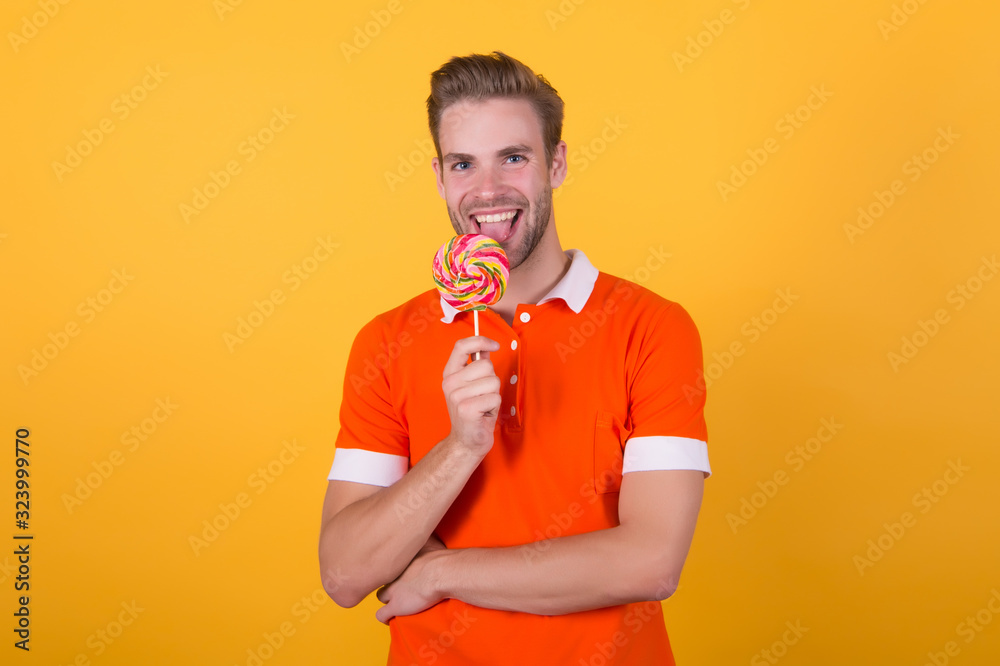Happy eating sweets. Symbol of happiness. Man eat lollipop. Man smiling ...