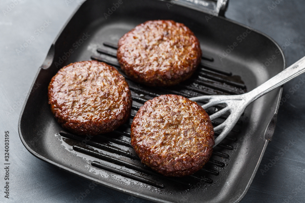 Cooking process of beef patties on pan Stock Photo | Adobe Stock