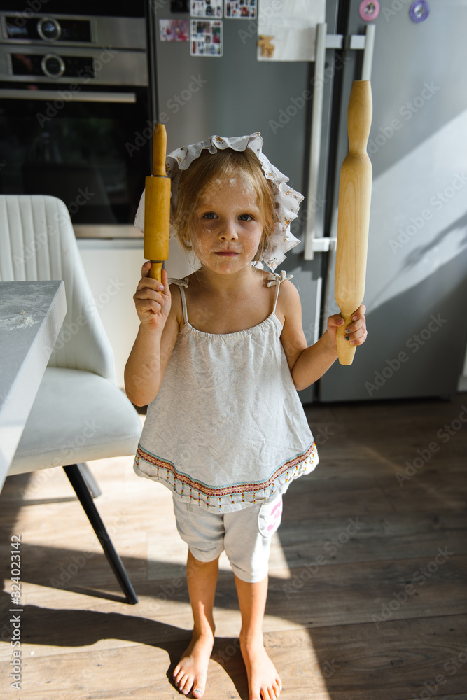 Little girl cooking pizza in the kitchen Stock Photo | Adobe Stock