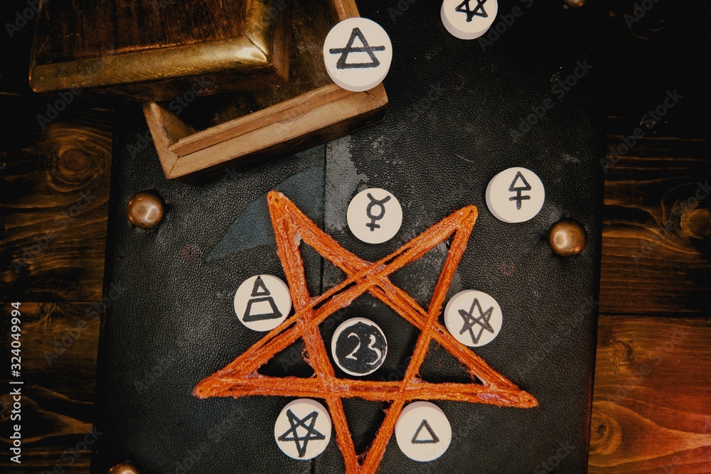 Pentagram and religious symbols on an old book.Pentagram on an old ...