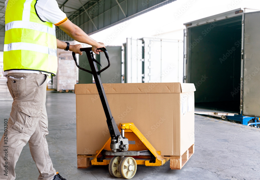 Workers Courier Using Hand Pallet Jack Unloading Package Boxes into ...