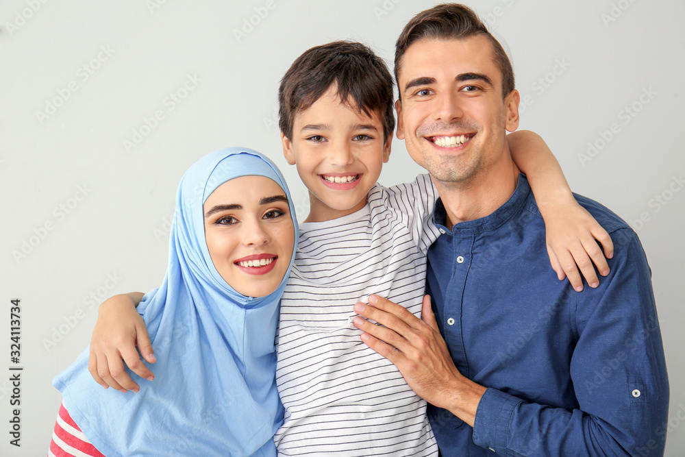 Portrait of Muslim family on light background Stock Photo | Adobe Stock