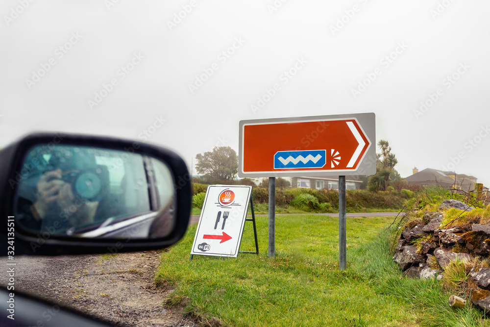 Road signs and a car mirror with the photographer’s reflection Stock ...