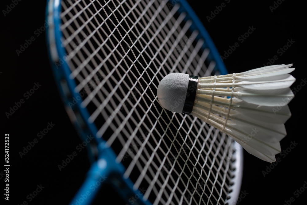 Badminton shuttlecock and badminton racket in the black background used ...
